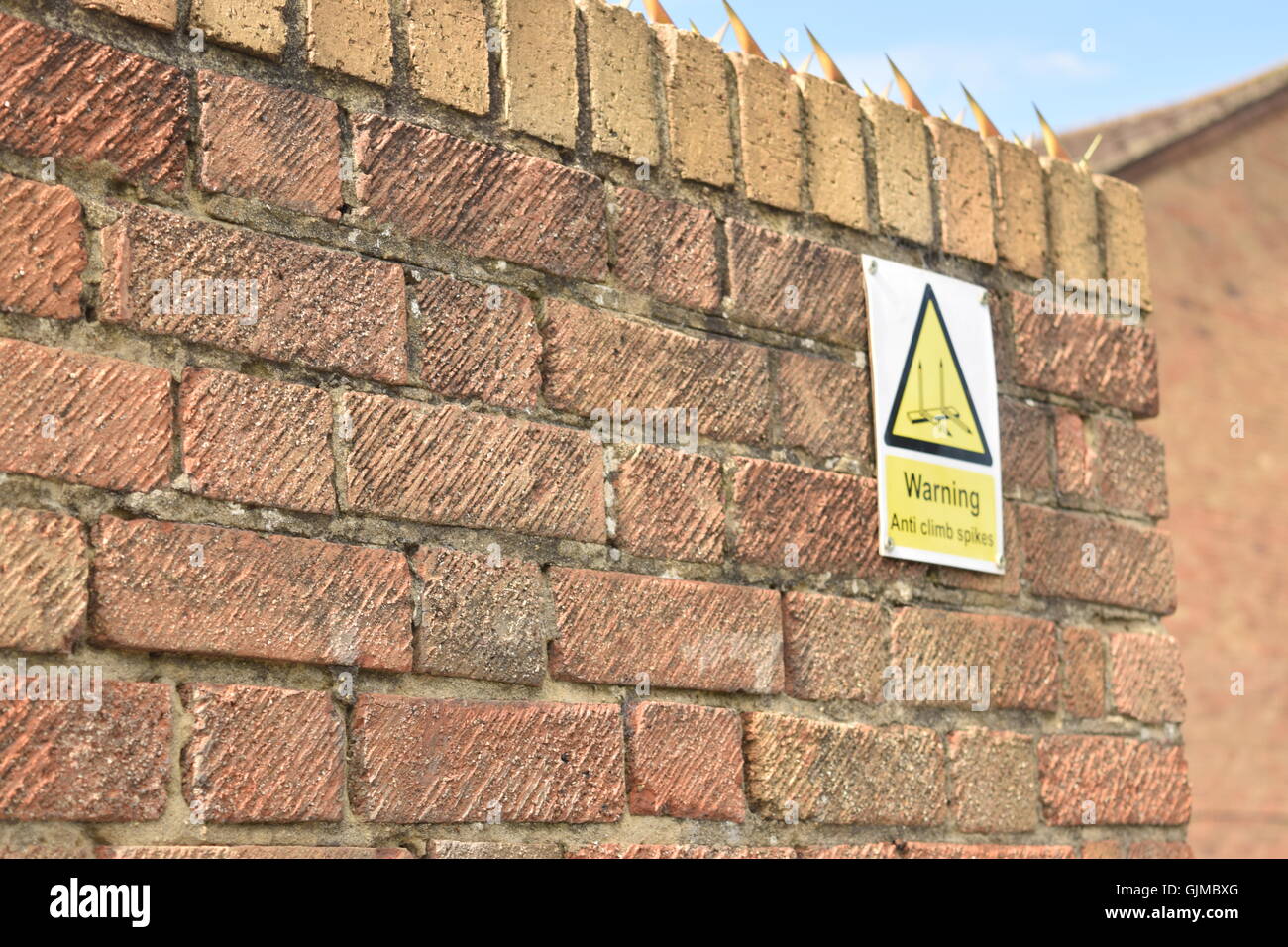 Warning Sign on a Brick Wall Stock Photo - Alamy