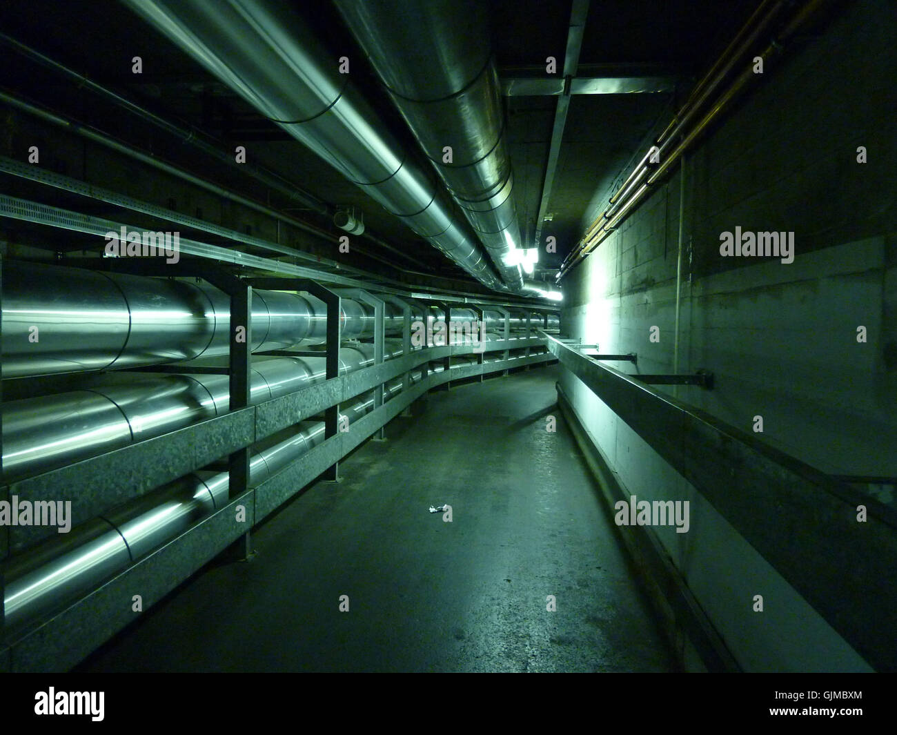 Underground tunnel with metallic pipes Stock Photo - Alamy