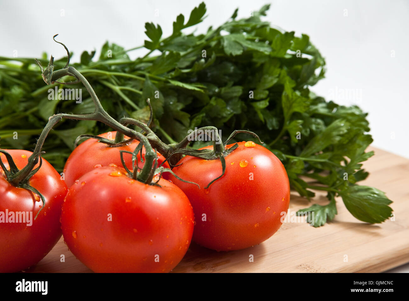Tomato with parsely Stock Photo - Alamy