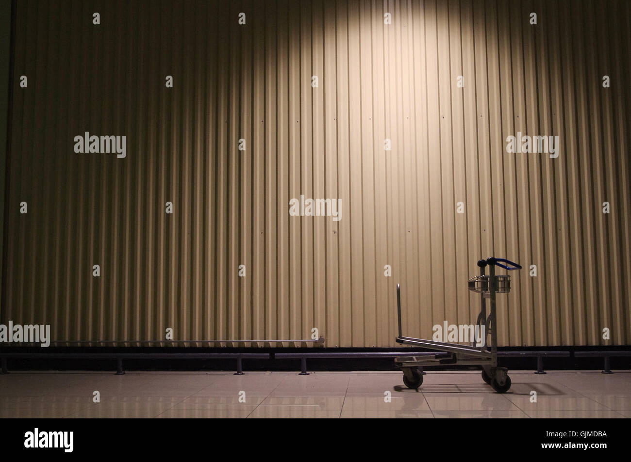 Trolley in empty warehouse Stock Photo - Alamy