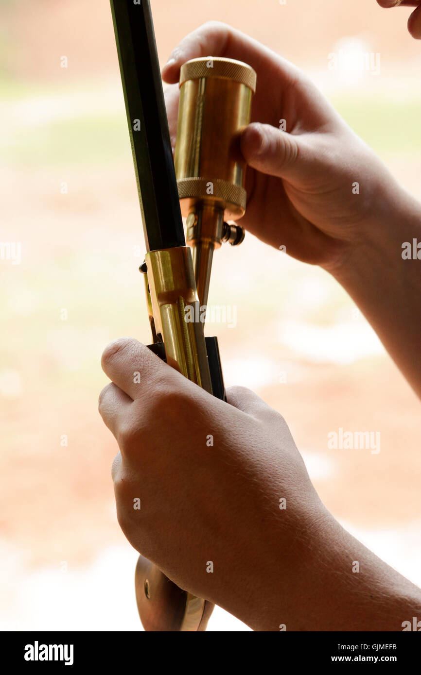 Loading a black powder revolver Stock Photo - Alamy