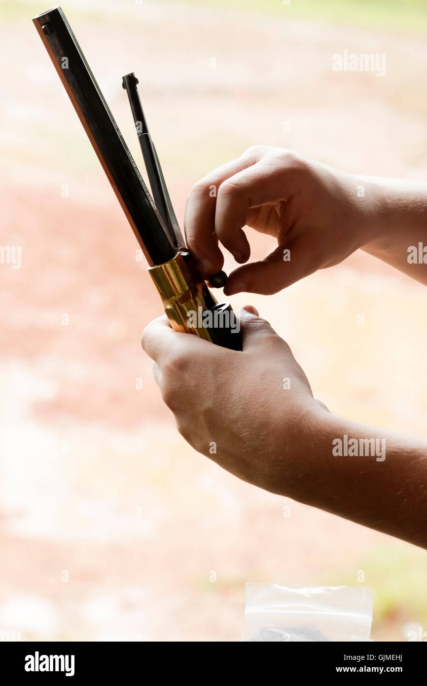 Loading a black powder revolver Stock Photo - Alamy