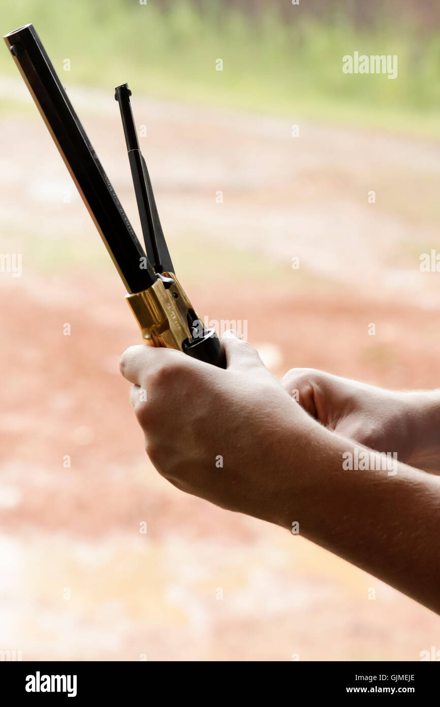Loading a black powder revolver Stock Photo - Alamy