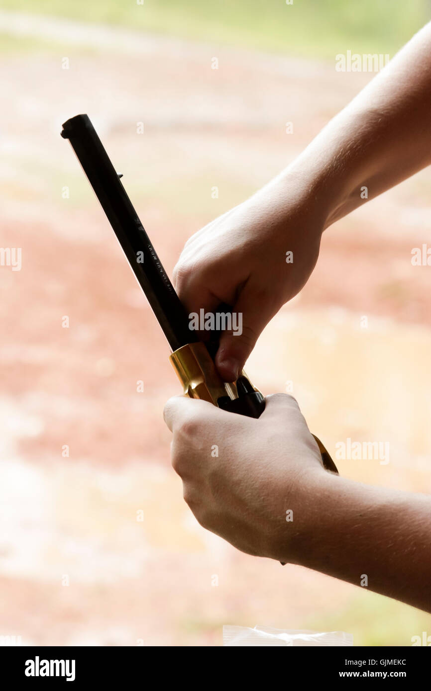 Loading a black powder revolver Stock Photo - Alamy