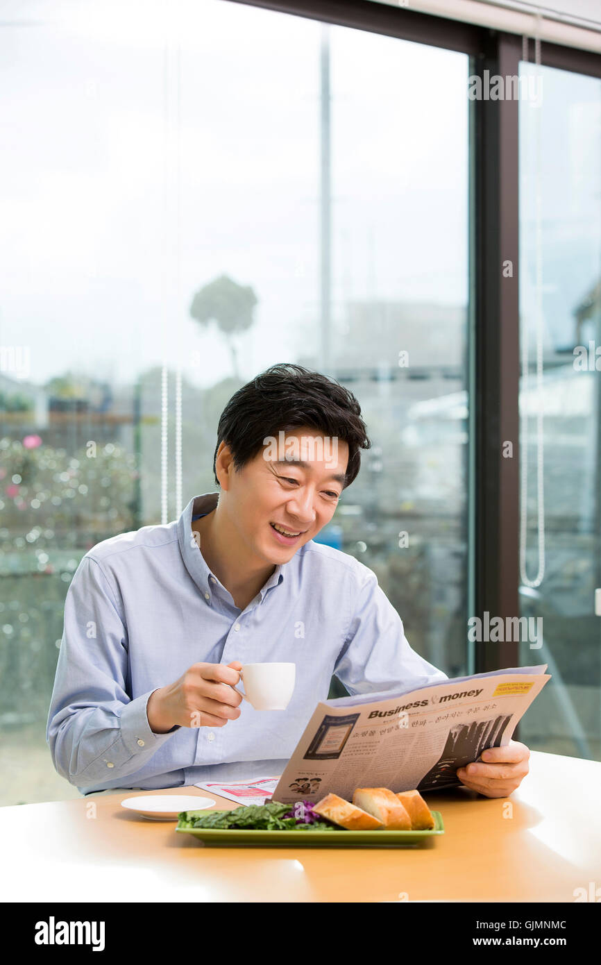 Middleaged asian man reading hi-res stock photography and images - Alamy