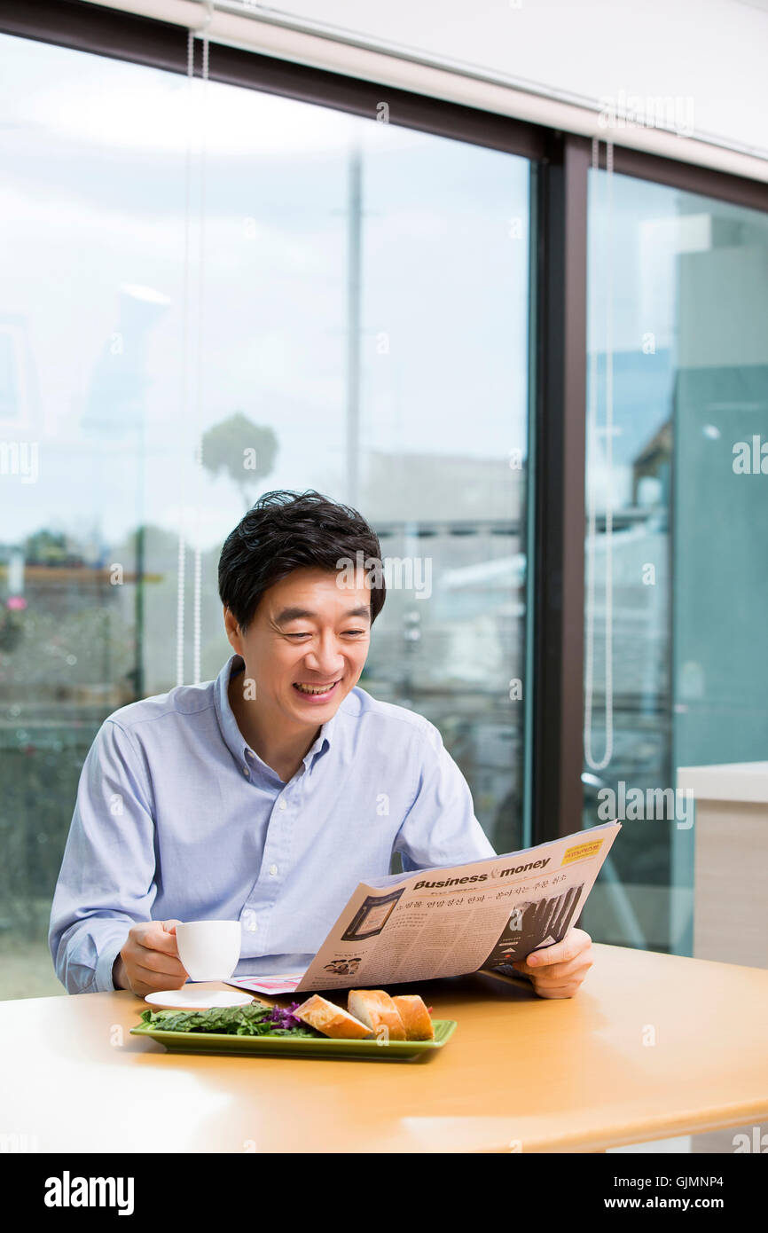 Middleaged asian man reading hi-res stock photography and images - Alamy