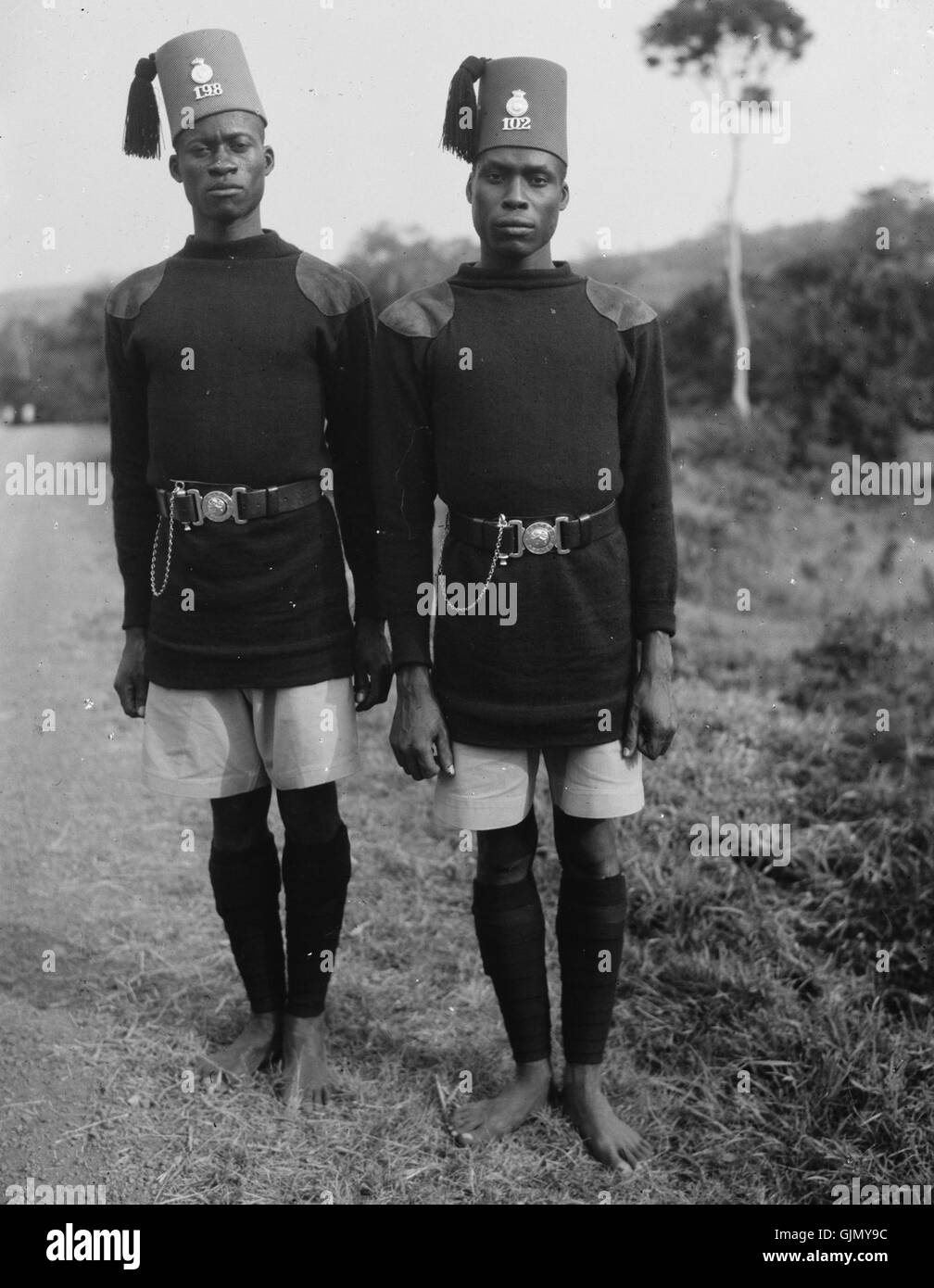 This image shows two soldiers standing on Jinja Road in Uganda in 1936 ...