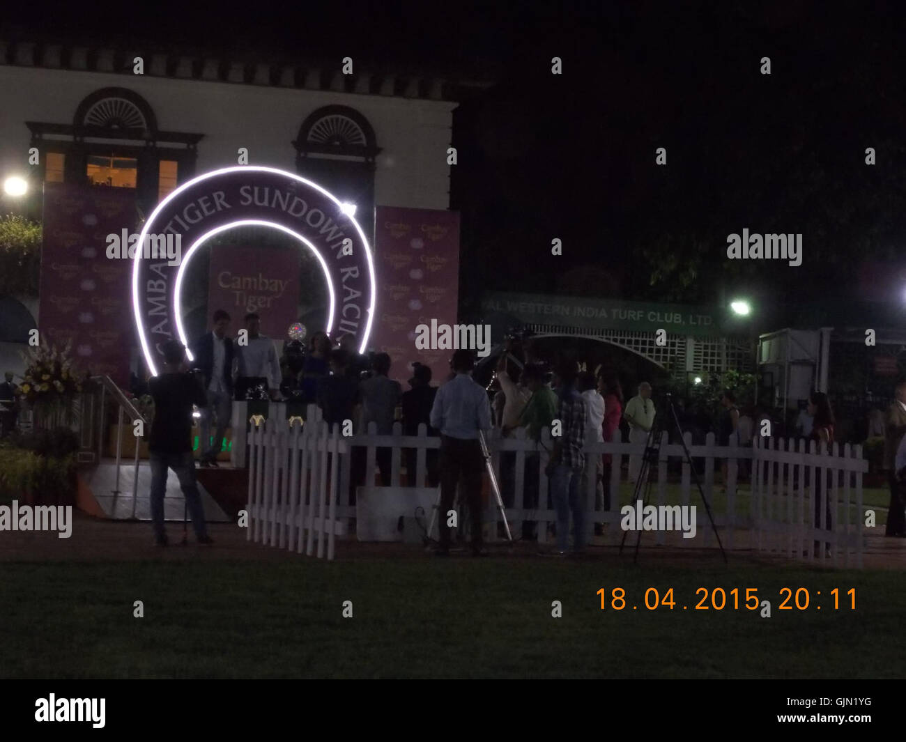 This photograph captures a night racing event at the paddock ...