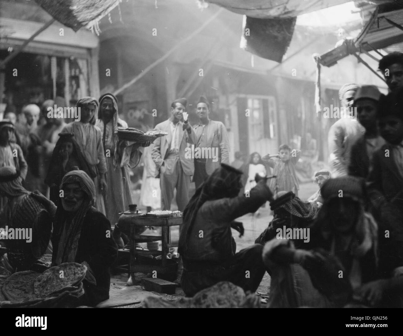 A photograph depicting a crowded marketplace in Mosul, Iraq, from 1932 ...