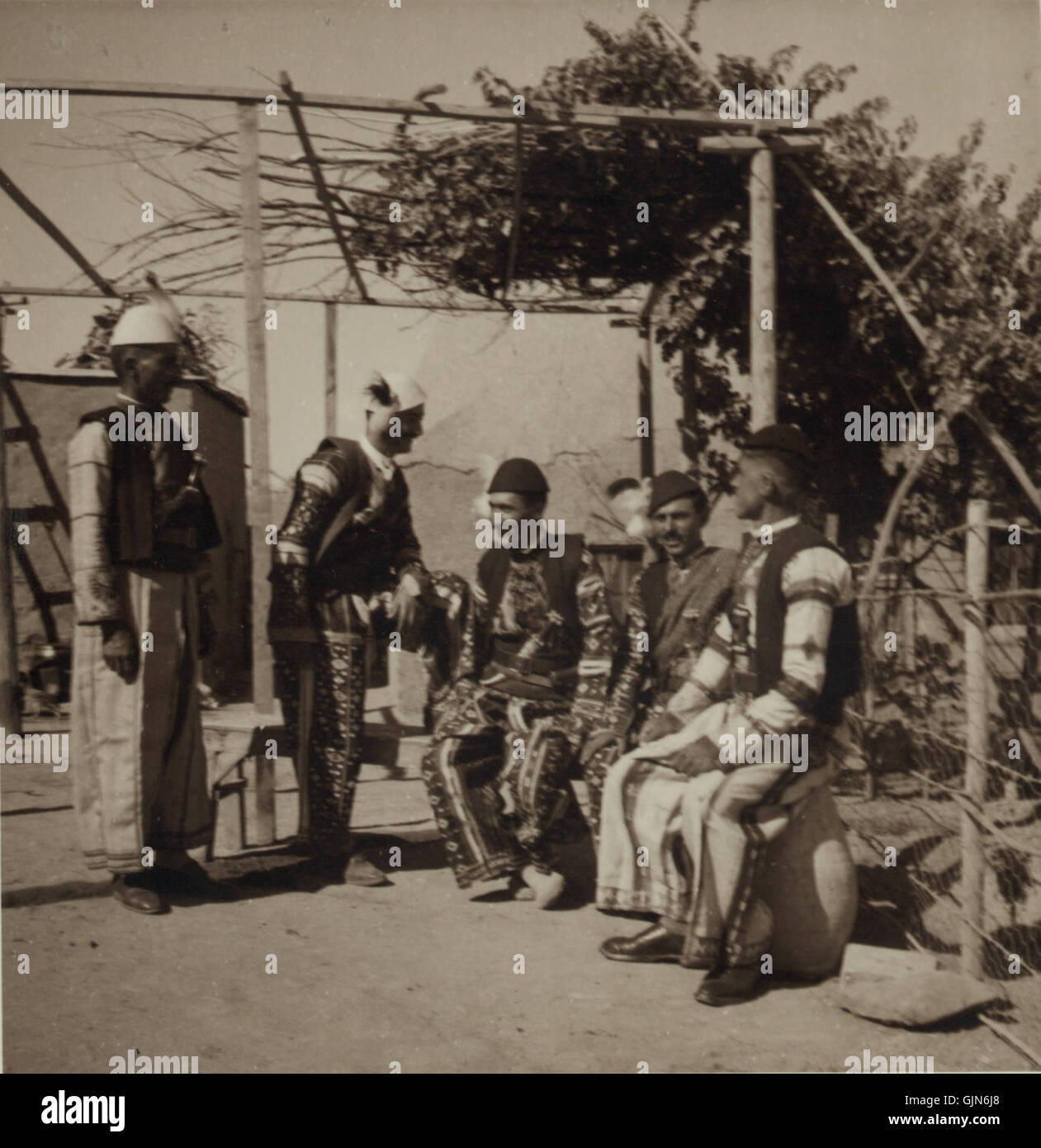 This image depicts a group of Assyrian men, representing the ancient ...