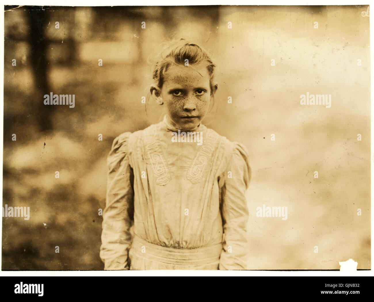 This poignant photograph by Lewis Hine captures a young girl working in ...