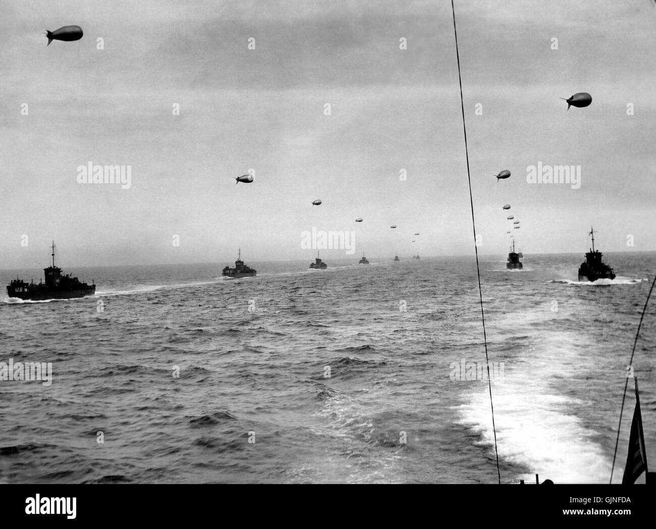 This historical image shows observation balloons tethered to ships, a ...