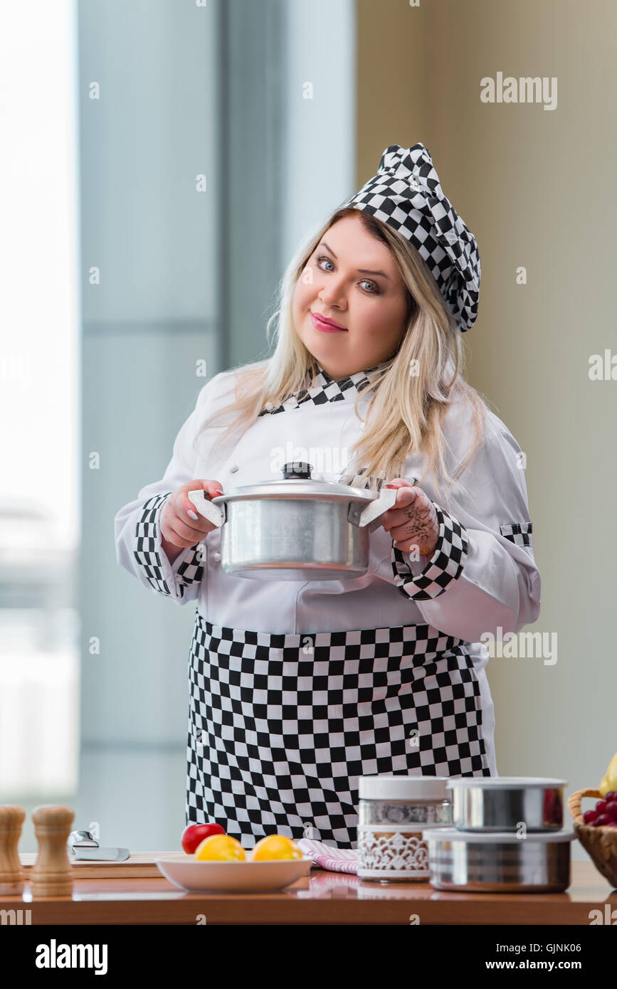 Female cook preparing soup in brightly lit kitchen Stock Photo - Alamy