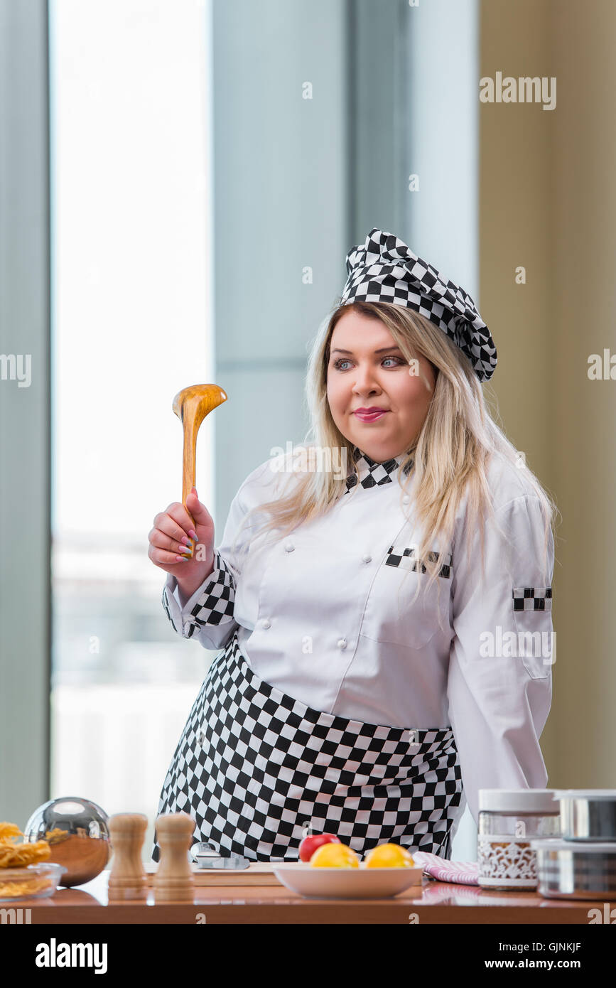 Female cook preparing soup in brightly lit kitchen Stock Photo - Alamy