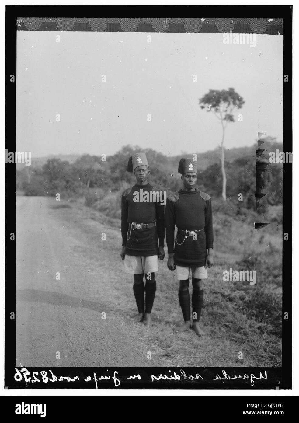 This photograph shows two soldiers on Jinja Road, Uganda, taken in 1936 ...