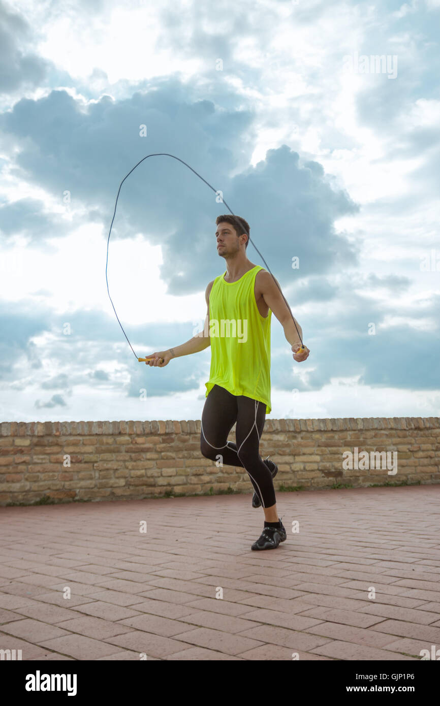 Young man jumping rope sky sunny Stock Photo - Alamy