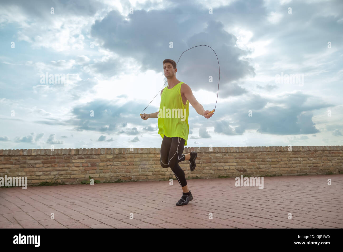 Young man jumping rope sky sunny Stock Photo - Alamy