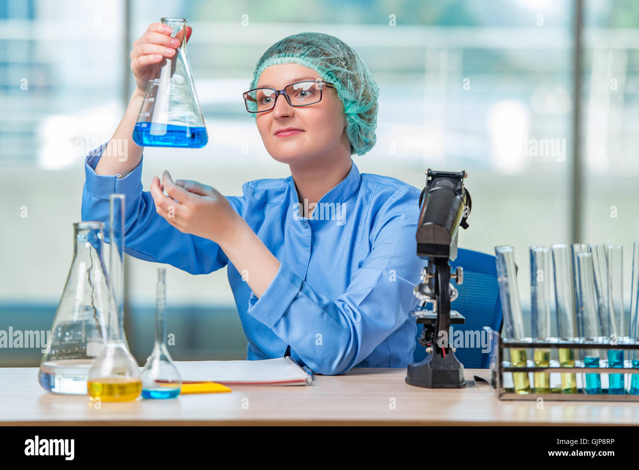 Experienced lab assistant working on chemical solutions Stock Photo - Alamy