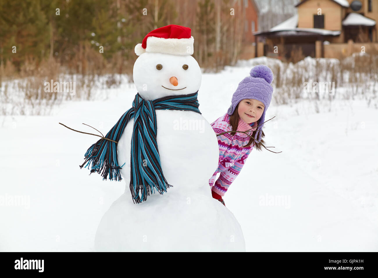 kid playing with snowman Stock Photo - Alamy
