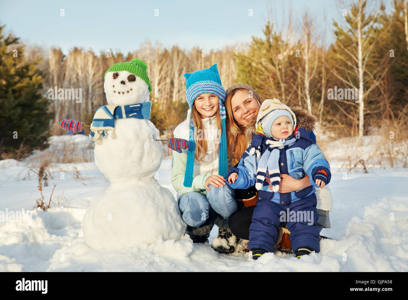 Happy family and snowman hi-res stock photography and images - Alamy