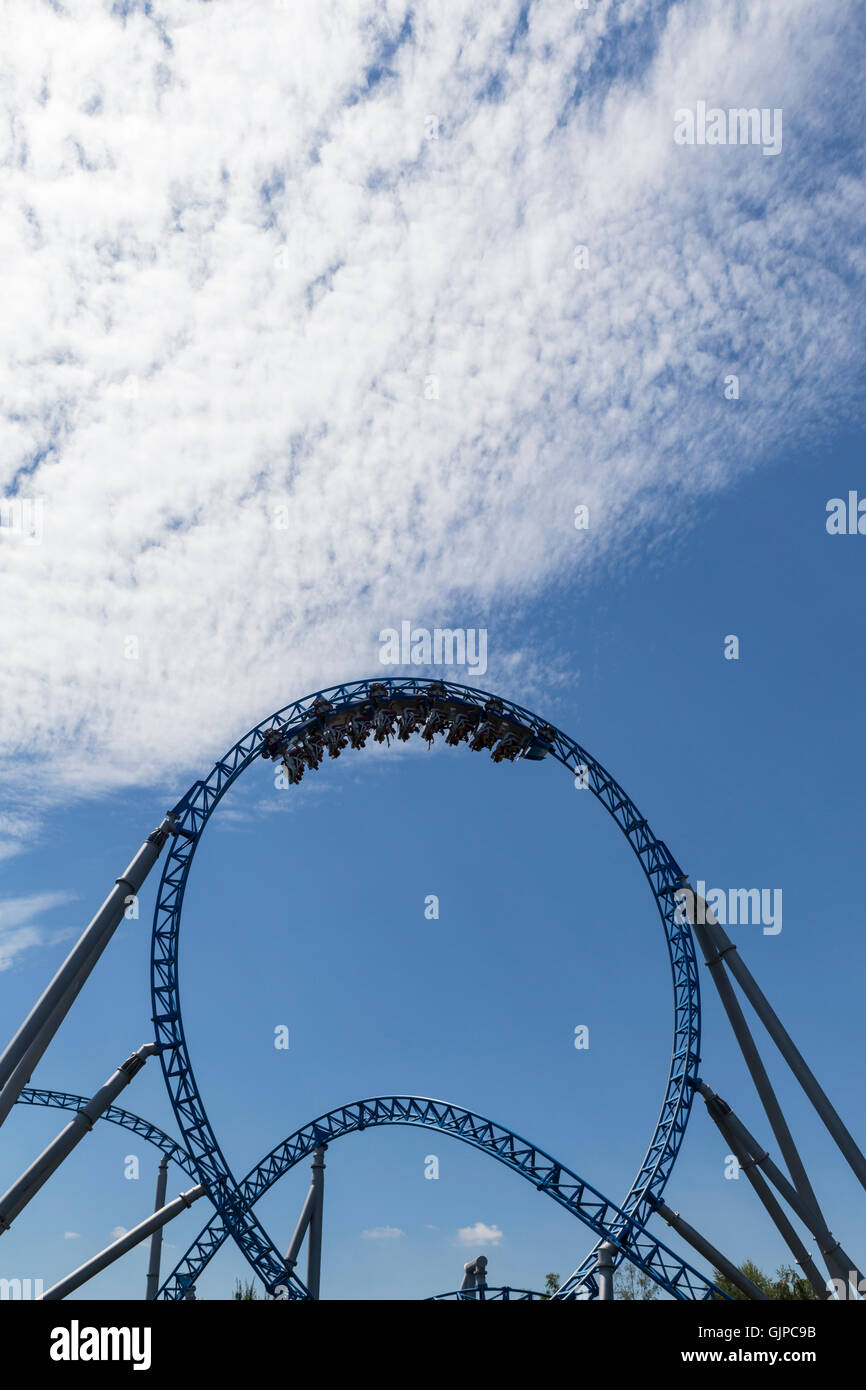 blue roller coaster loop with cart in front of blue sky Stock Photo - Alamy