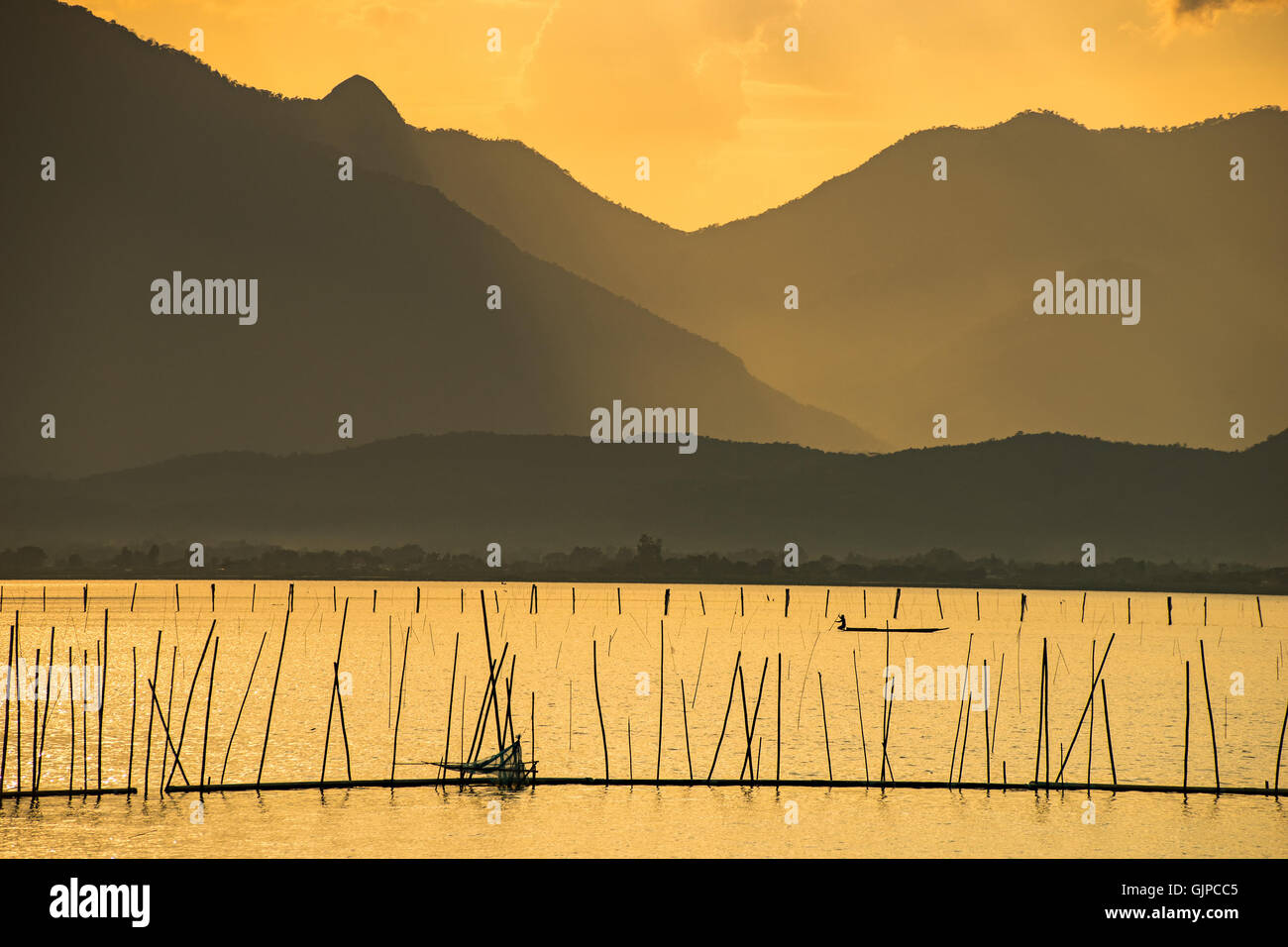 Golden hour sunset landscape with fisherman and boat on the lake Stock ...