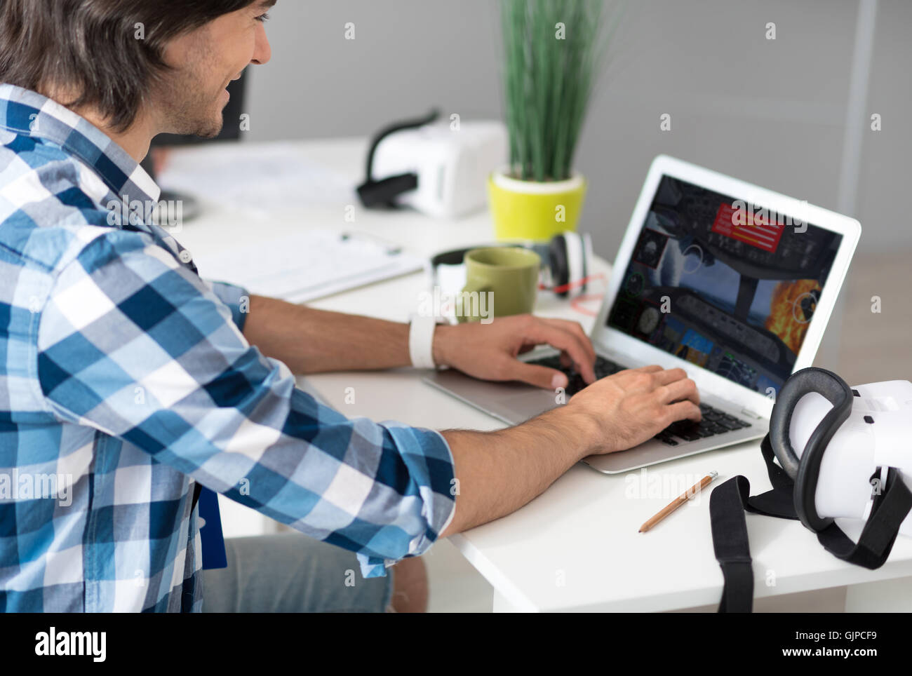 Cheerful smiling man playing computer games Stock Photo - Alamy