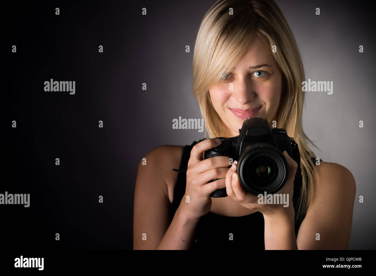 pretty young woman with camera Stock Photo - Alamy