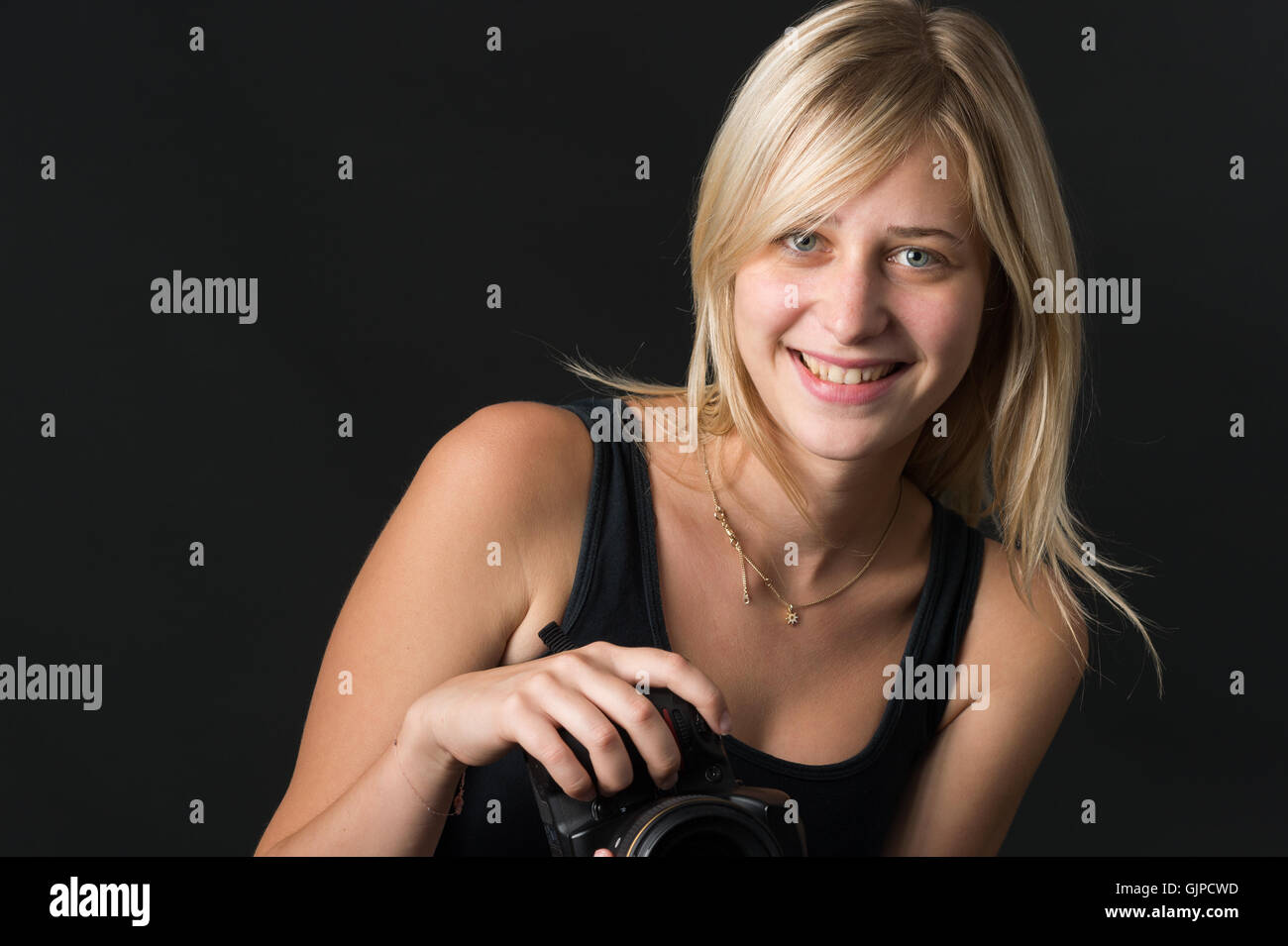 pretty young woman with camera Stock Photo - Alamy