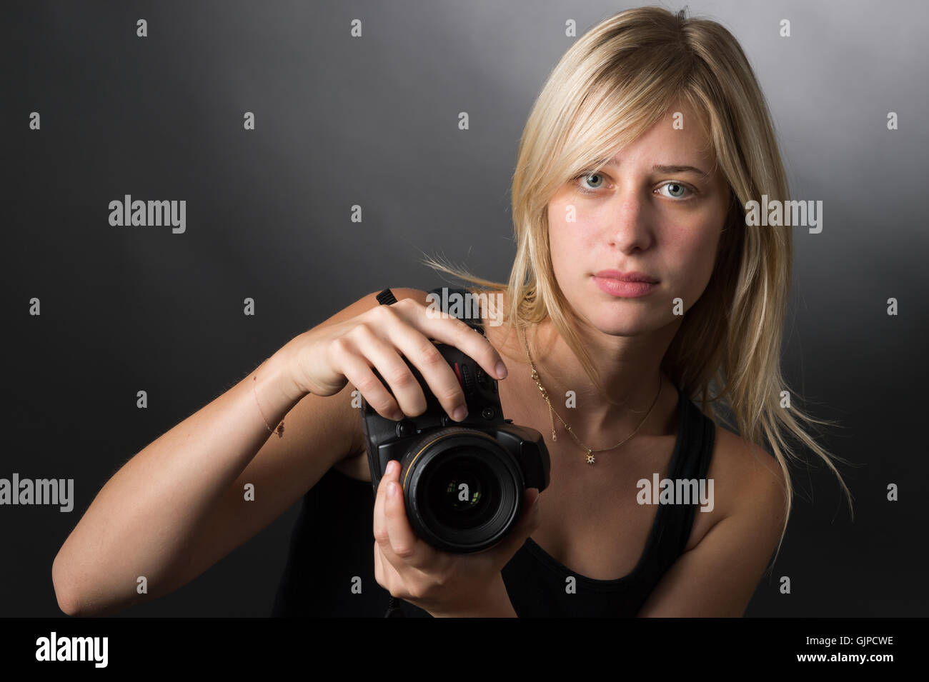 pretty young woman with camera Stock Photo - Alamy