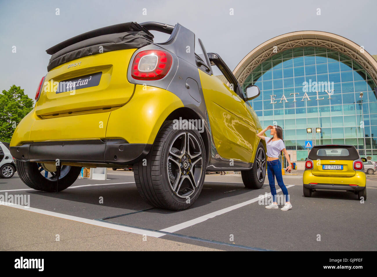 A giant Smart car next to a standard size Smart car in Rome Featuring ...