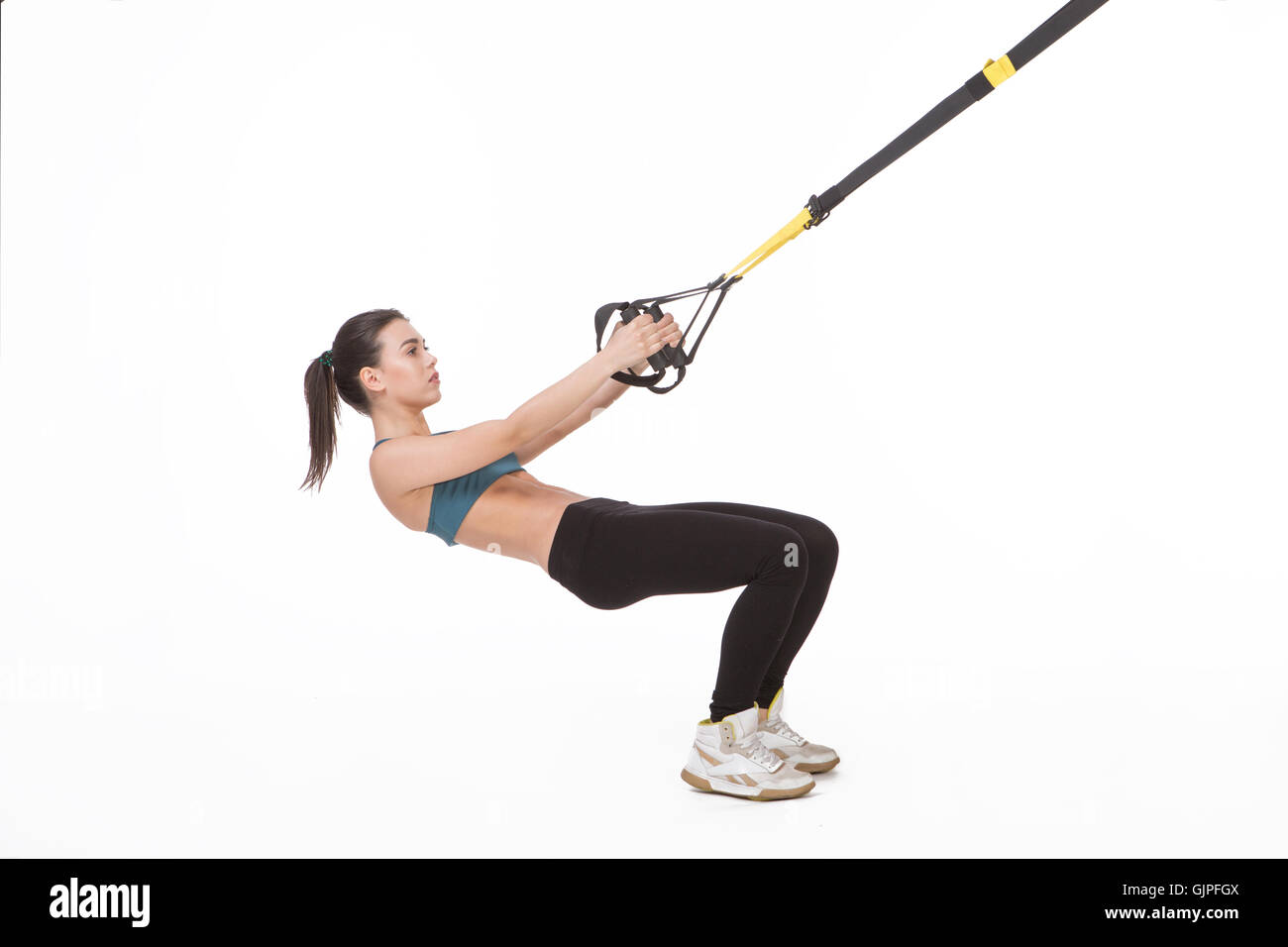 Woman training with suspension trainer sling Stock Photo - Alamy