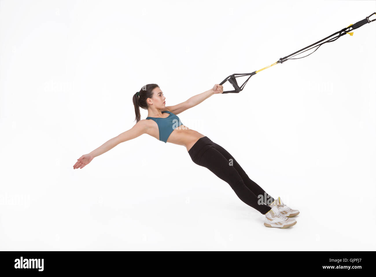 Woman training with suspension trainer sling Stock Photo - Alamy