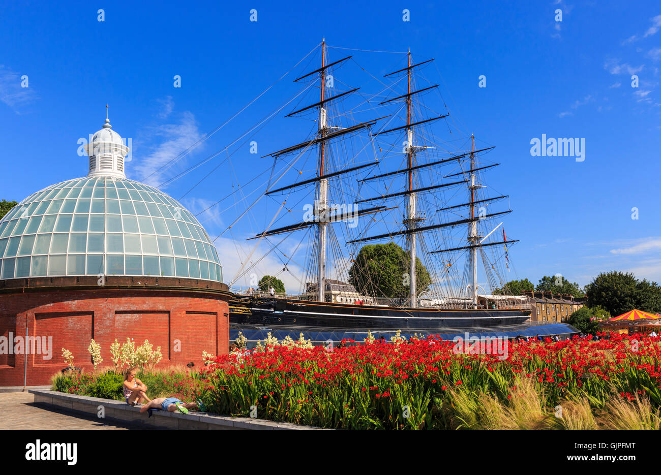 The Cutty Sark, a restored tea clipper ship, with the entrance to ...