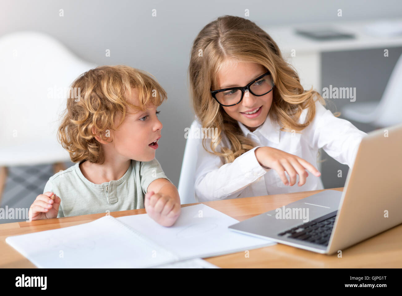Girl pointing at screen of laptop Stock Photo - Alamy