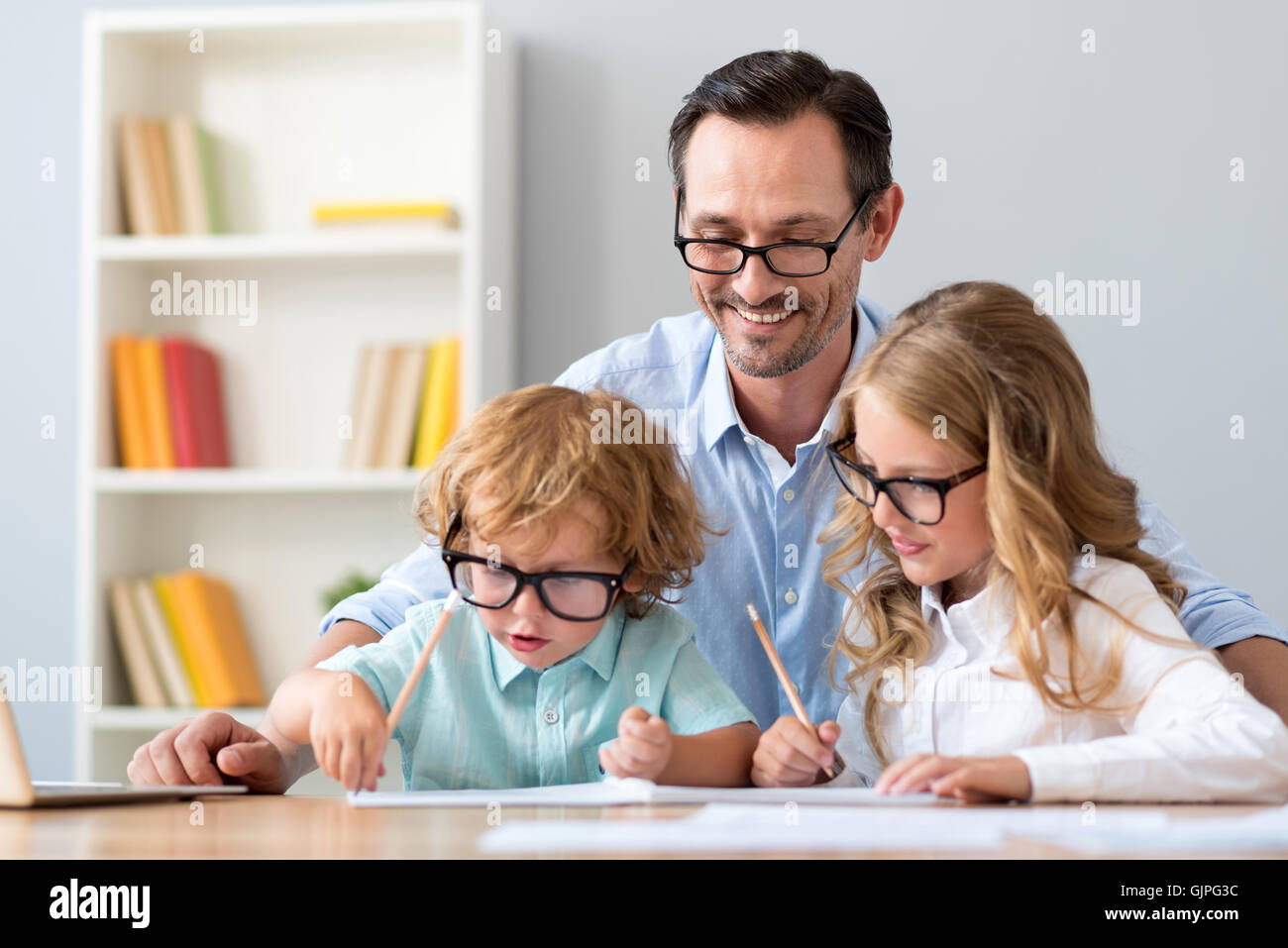 Man and girl how boy drawing Stock Photo - Alamy