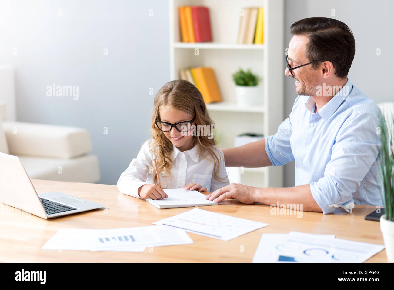 Man looking how girl writing Stock Photo - Alamy
