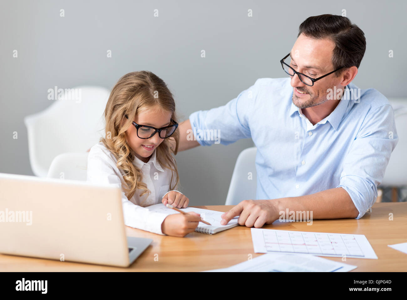 Man and girl counting on the paper Stock Photo - Alamy