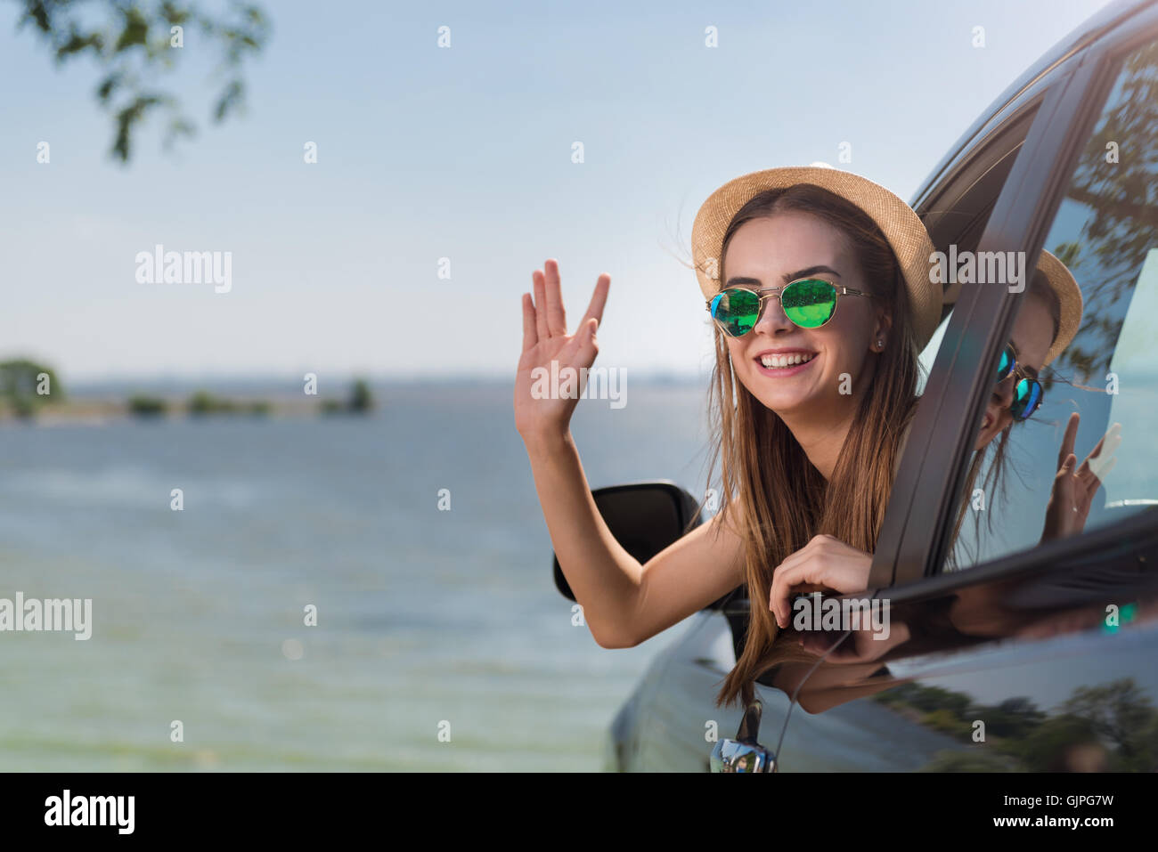Positive woman sitting in the car Stock Photo - Alamy