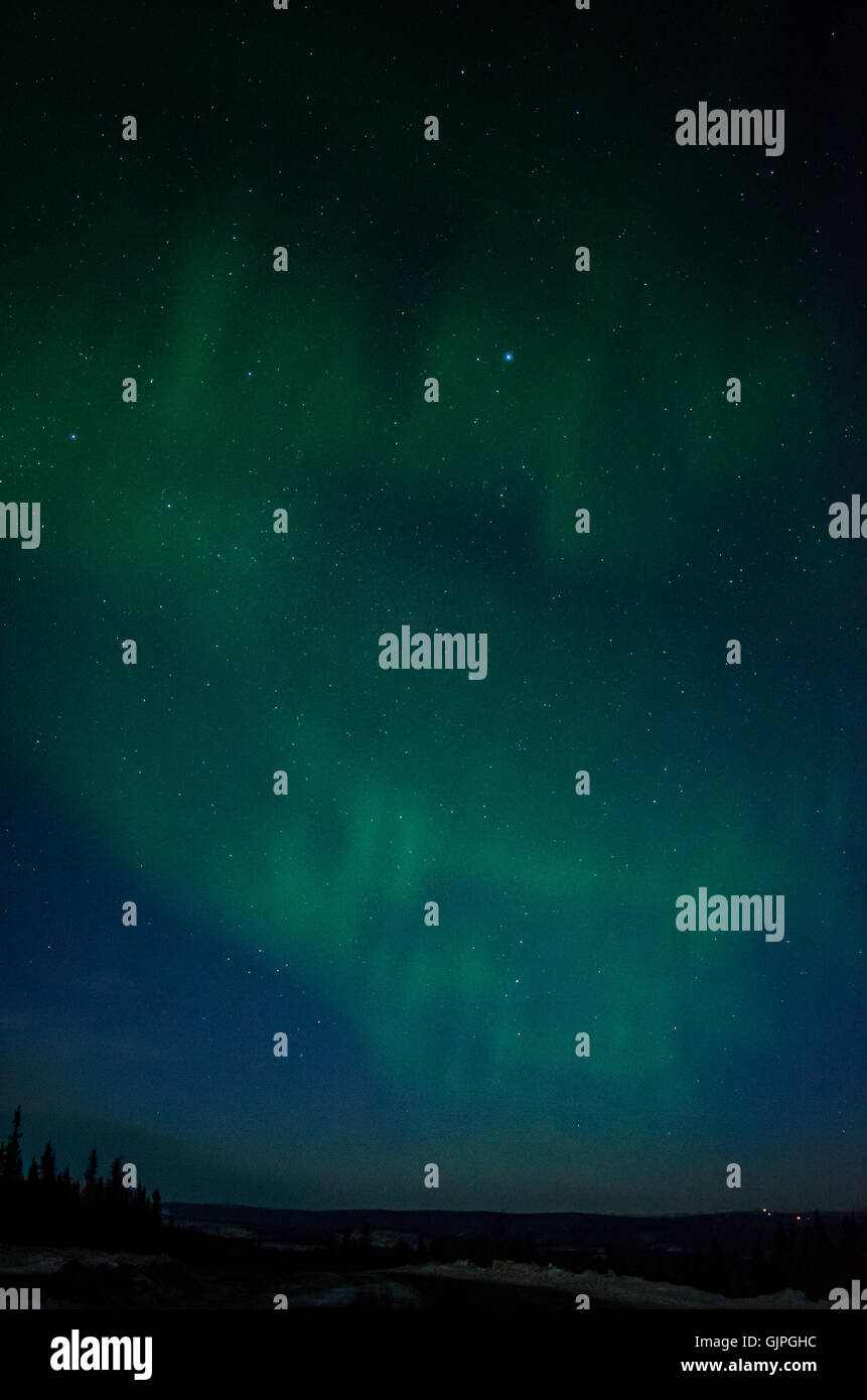 An aurora weaves green ribbons across the sky Stock Photo - Alamy