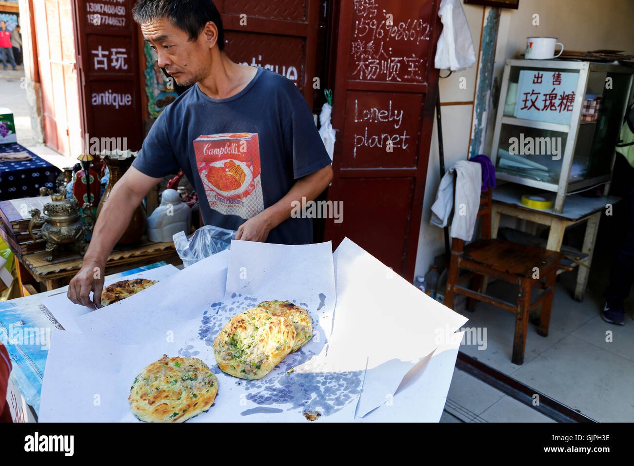 Man selling baba, a traditional flatbread snack, Sifan Jie square ...