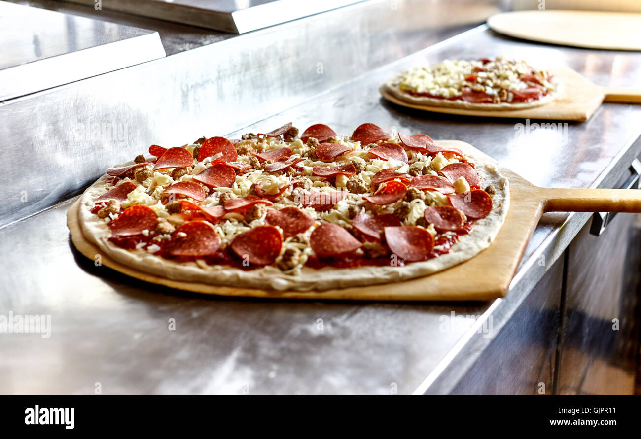 Uncooked pizza on stainless steel counter in Restaurant with shallow ...