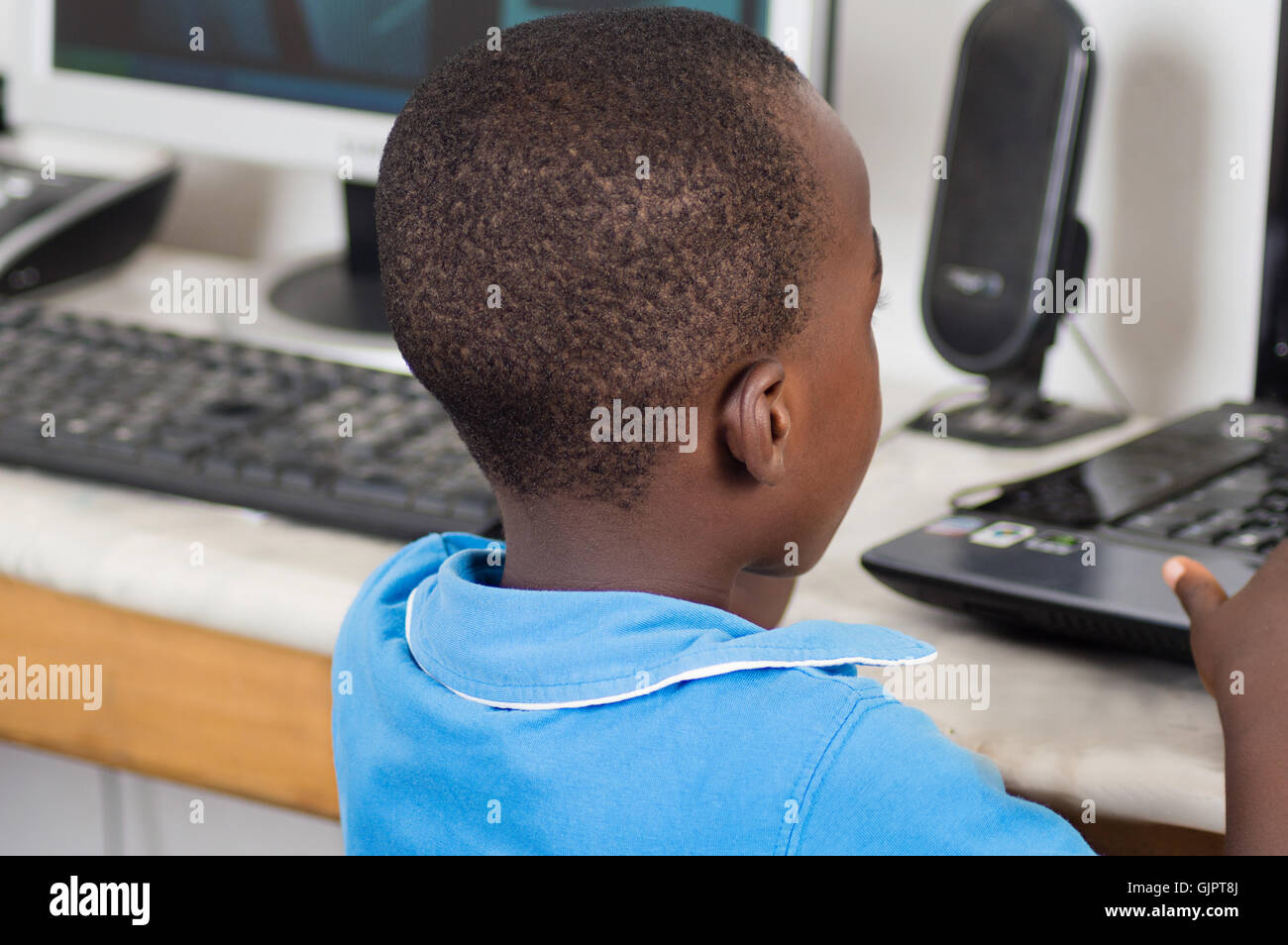curiosity gives the child a master of the computer Stock Photo - Alamy