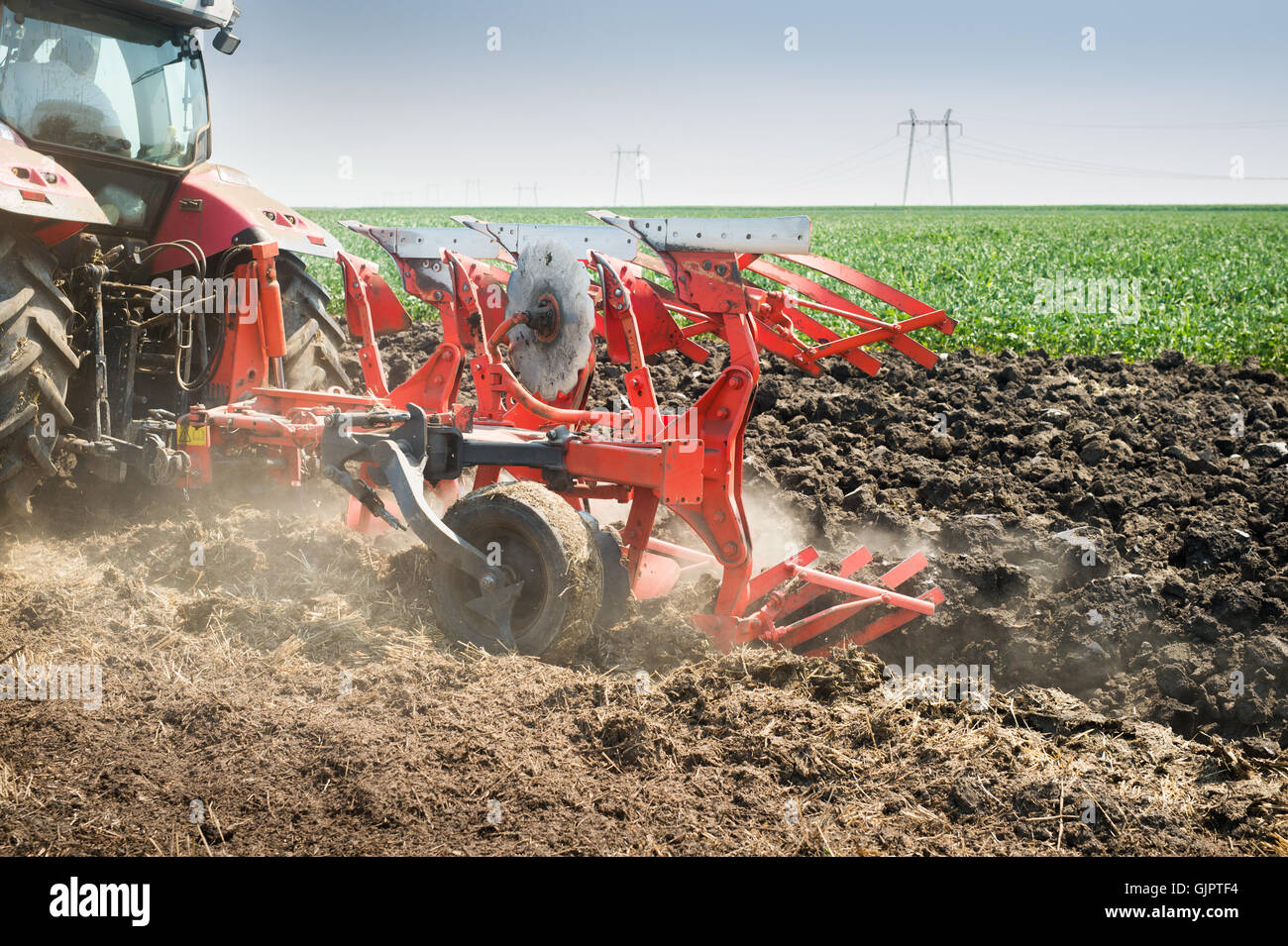 Tractor plowing the stubble field Stock Photo - Alamy