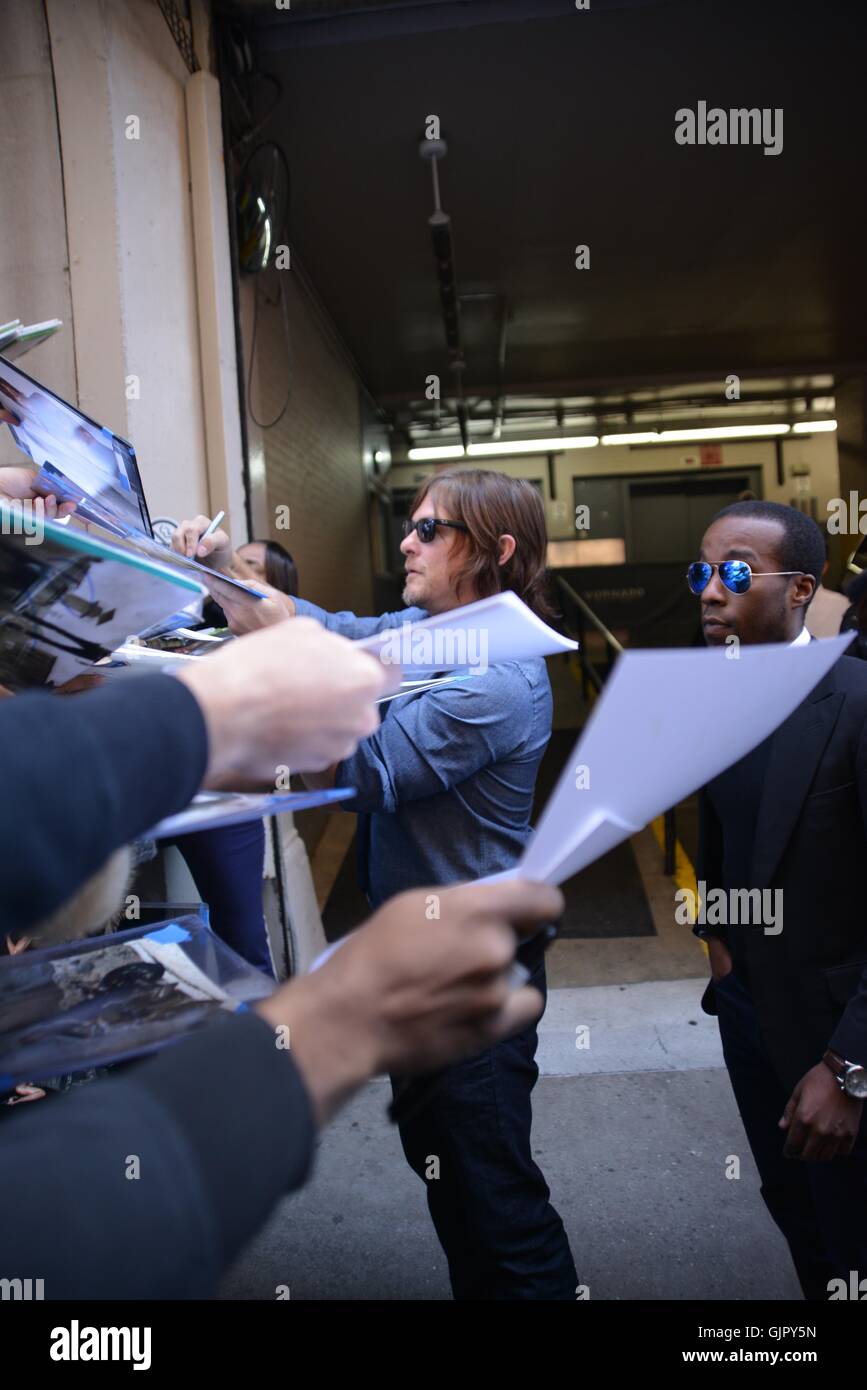 Norman Reedus signing autographs as he leaves a venue Featuring: Norman ...