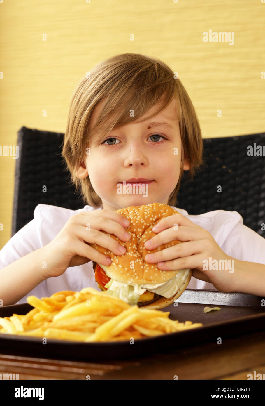 Young boy eating bun hi-res stock photography and images - Alamy