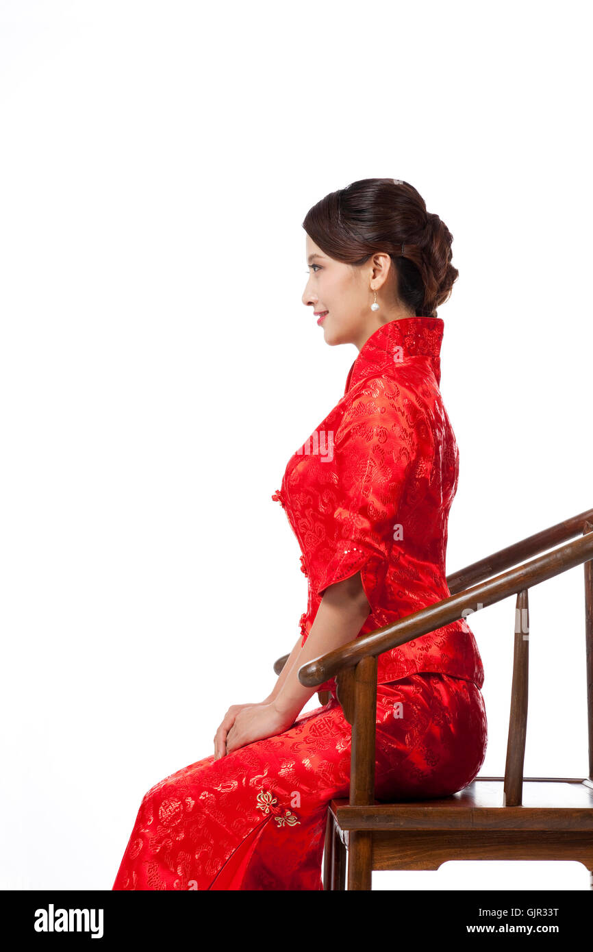 Dressed in traditional Chinese costumes studio shot young woman sitting ...