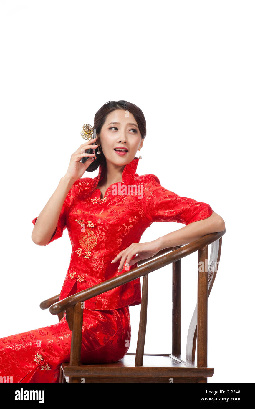 Dressed in traditional Chinese costumes studio shot young woman calling ...