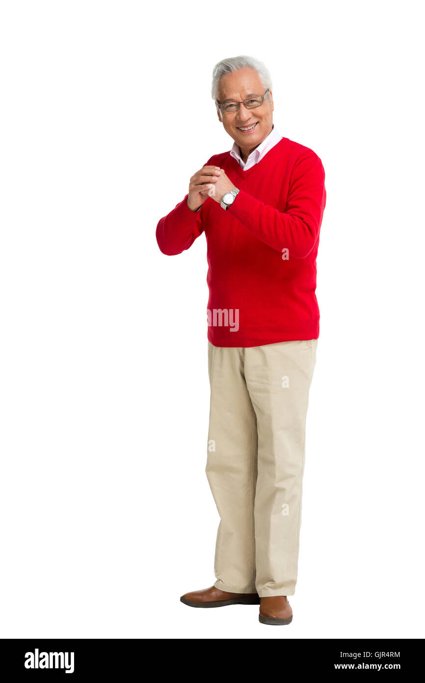 Studio shot of an old man Baoquan salute Stock Photo - Alamy