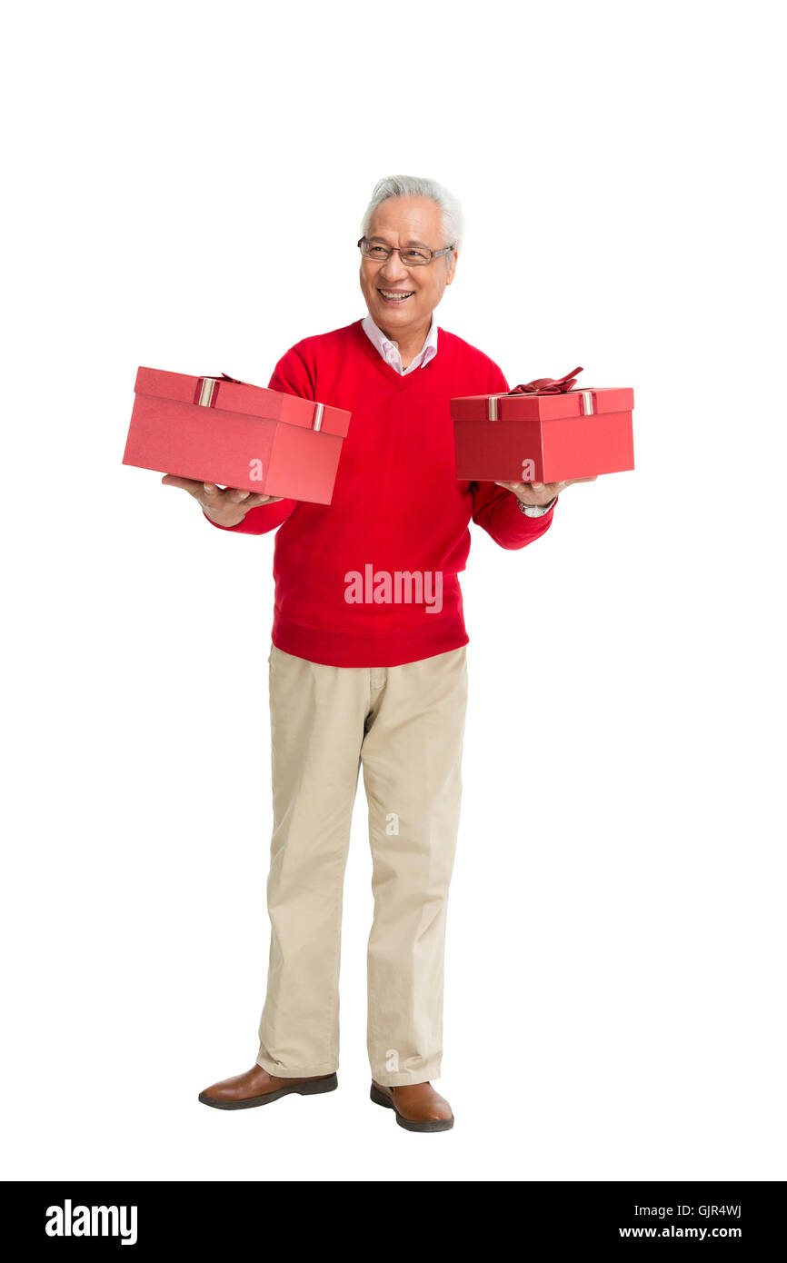 Studio shot of an old man holding a gift box Stock Photo - Alamy